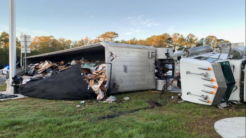 Garbage truck overturns at Walker South Rd.