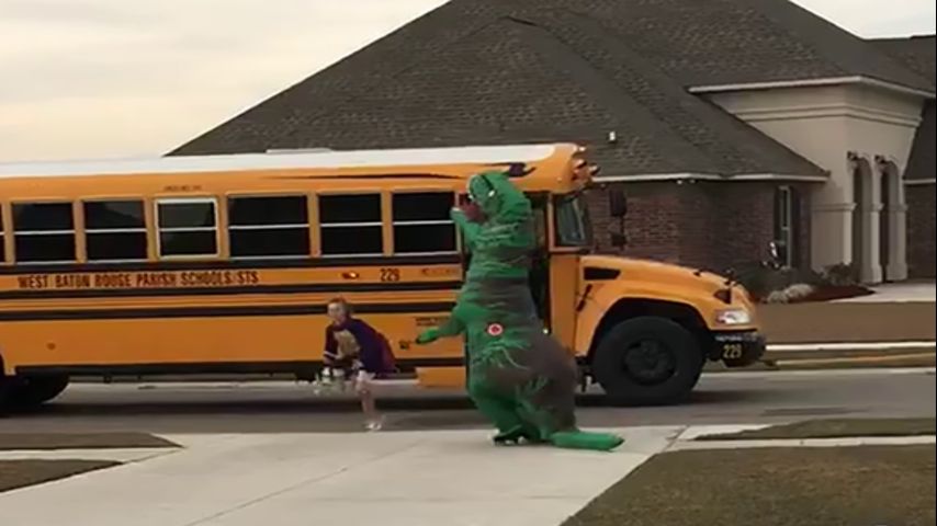 Video of area dad in T-Rex costume waiting for daughter's bus goes viral