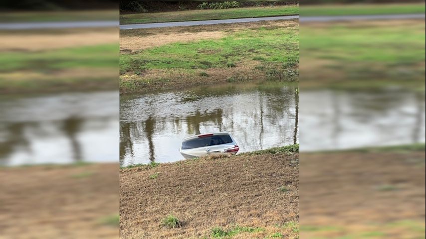 Car stuck in canal near University Lake; no injuries reported